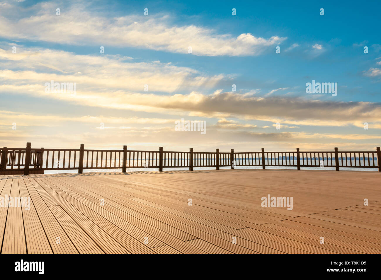 Lakeside wood floor platform and sky clouds at sunset Stock Photo - Alamy