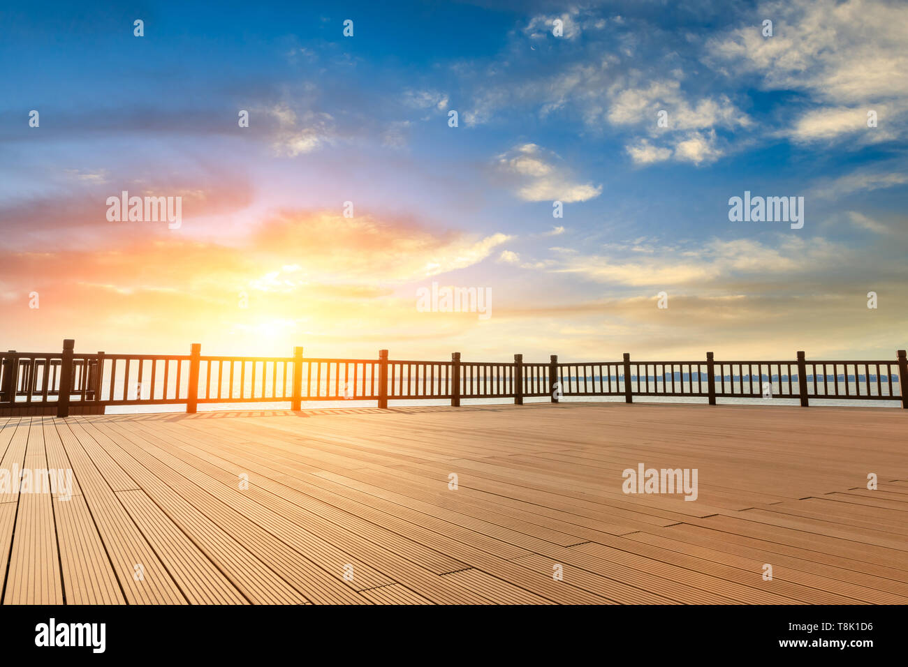 Lakeside wood floor platform and sky clouds at sunset Stock Photo - Alamy