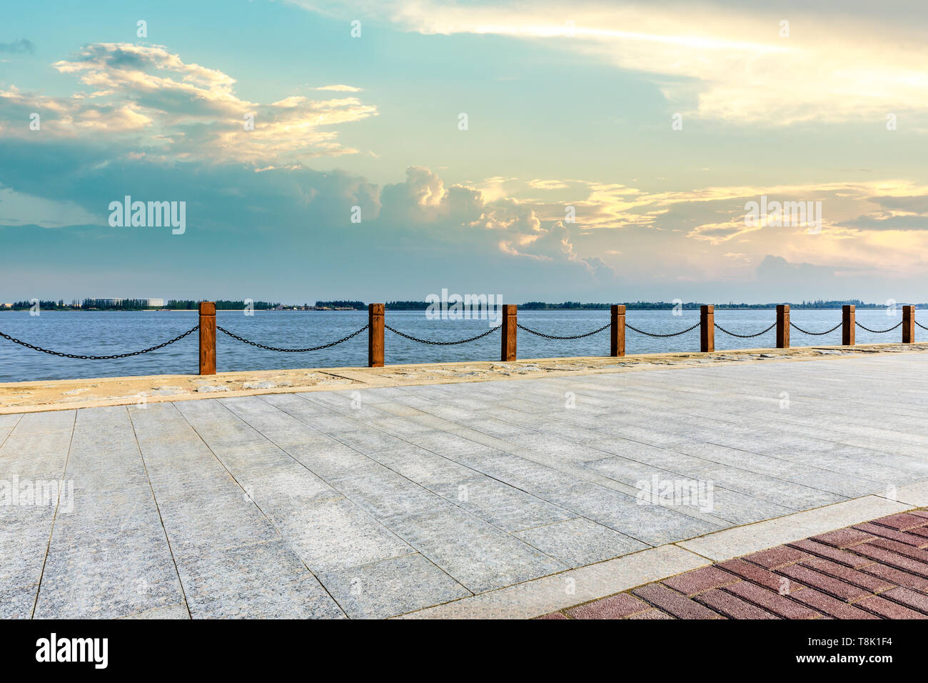 Beautiful lake and walkway with sky clouds at sunset Stock Photo - Alamy