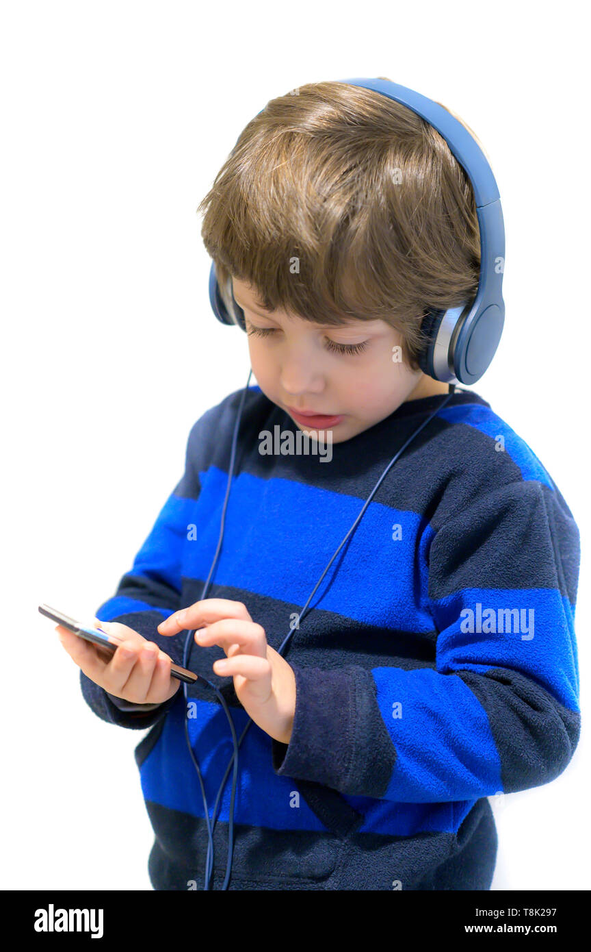 Cute boy listening music, wearing headphones isolated on white ...