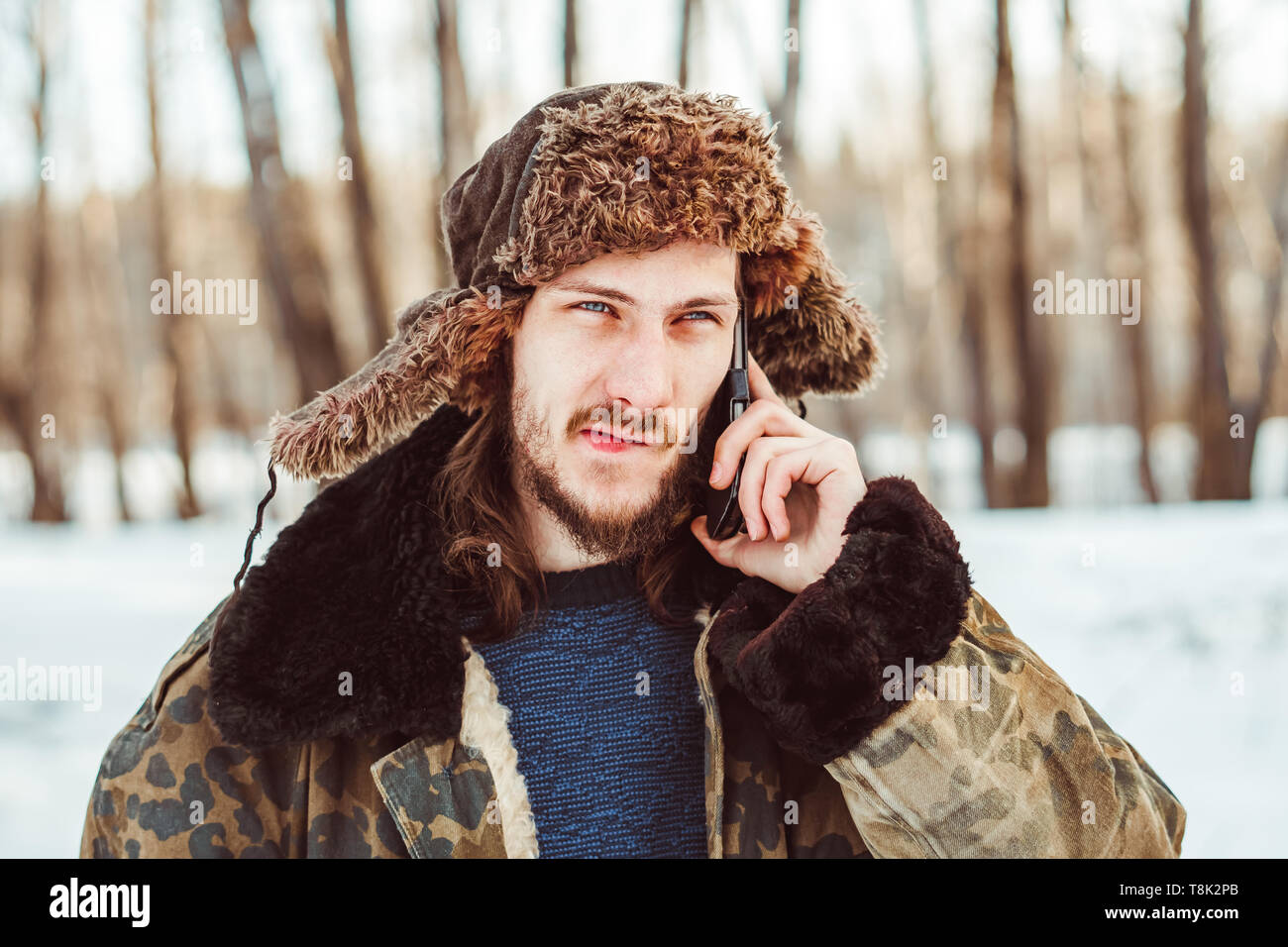 Siberian Russian man in a hat with headphones and phone Stock Photo - Alamy