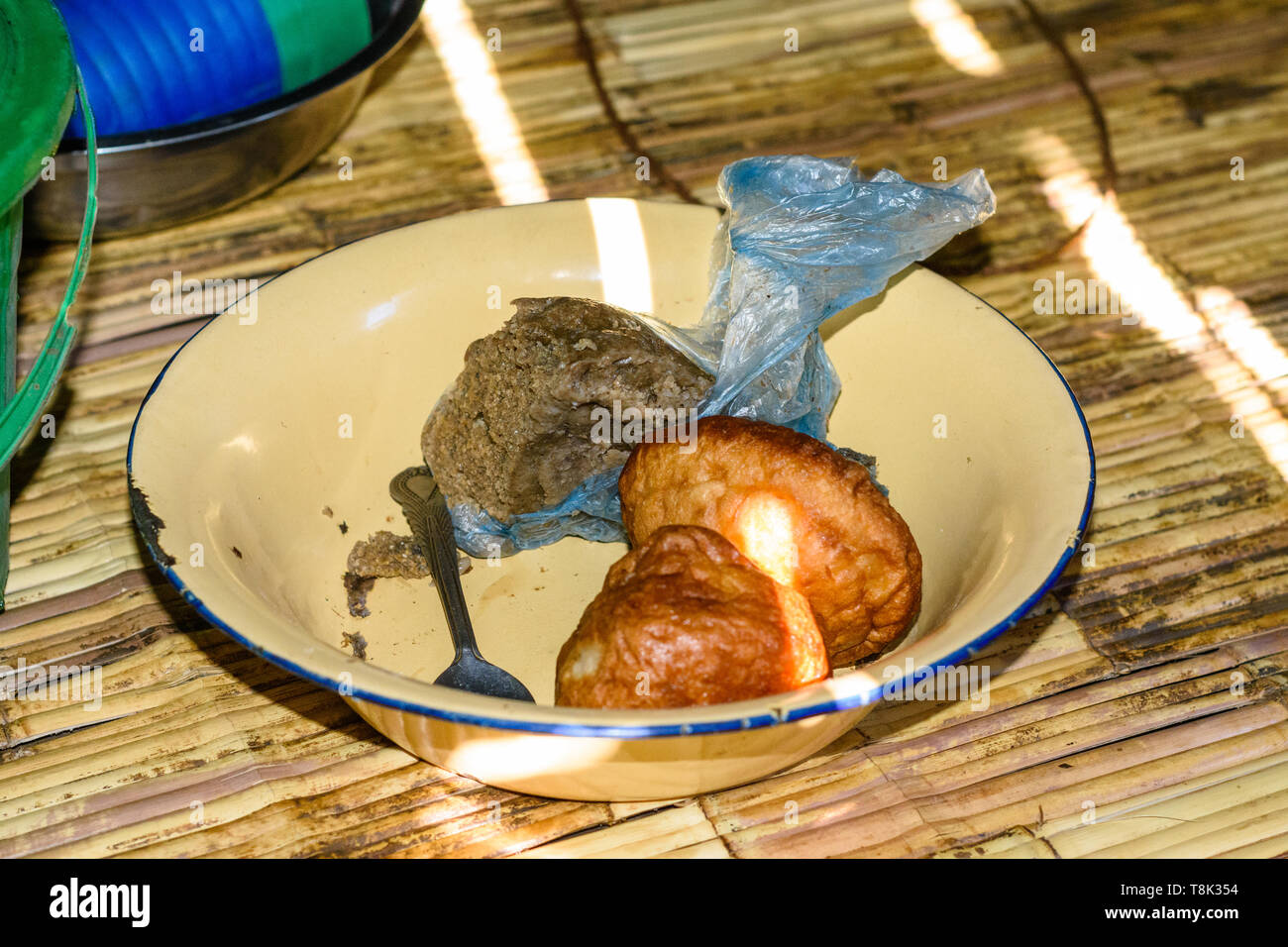 a Malawian village breakfast of donuts and bread made from millet flour ...