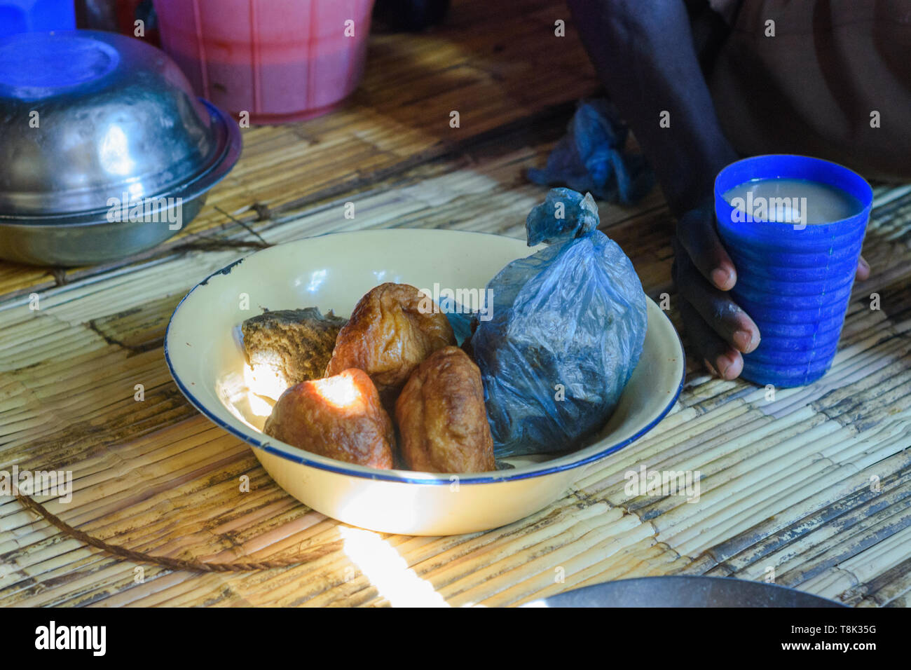 a Malawian village breakfast of donuts and bread made from millet flour ...