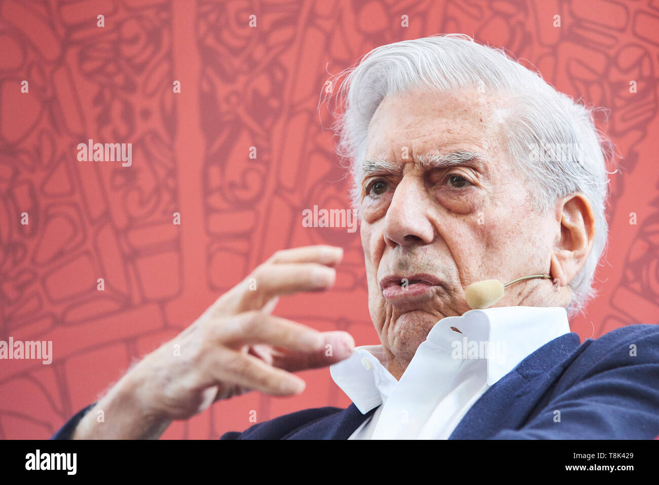 Peruvian-Spanish writer Mario Vargas Llosa speaking on stage. Book ...