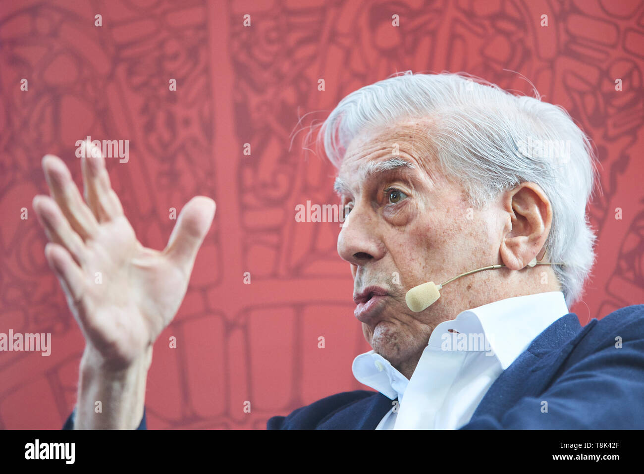 Peruvian-Spanish writer Mario Vargas Llosa speaking on stage. Book ...