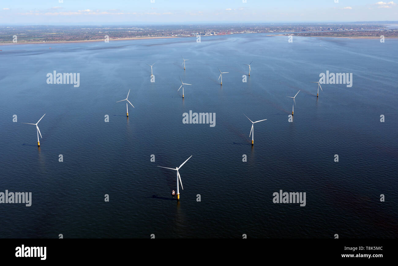 aerial view of a wind farm in the Irish Sea with Liverpool skyline in ...