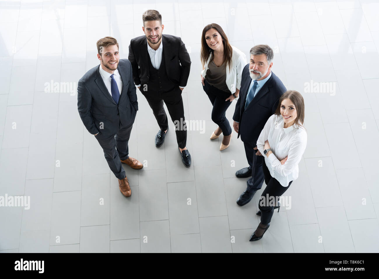 Full length confident business team stands in office Stock Photo - Alamy