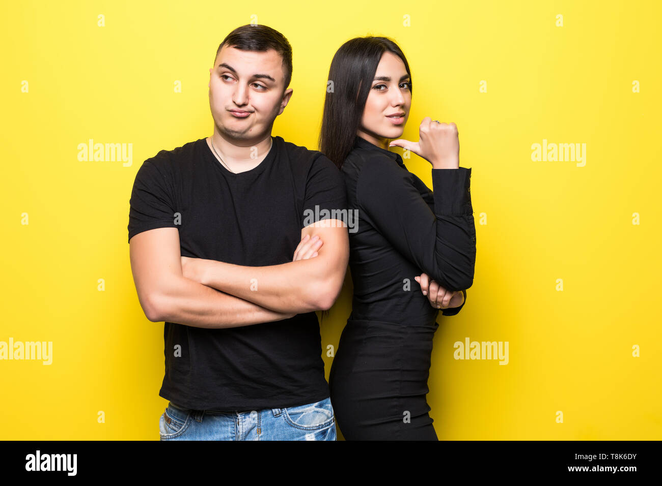 Portrait of woman pointed on bored man in casual clothes standing ...