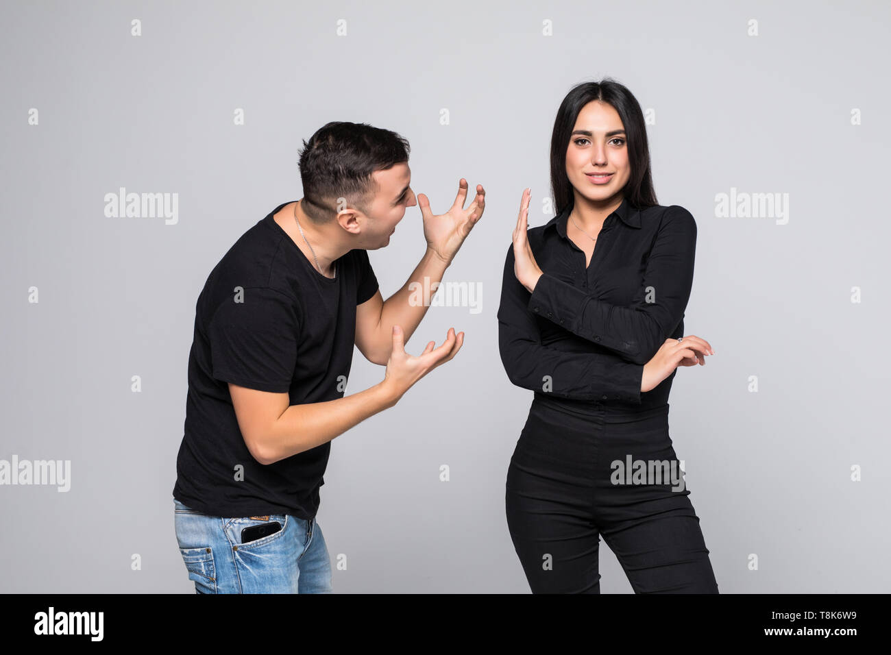Angry couple shouting at each other on white background Stock Photo - Alamy