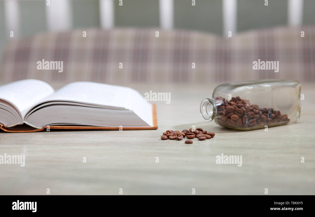 Open book on white table and coffee grains, education concept Stock ...