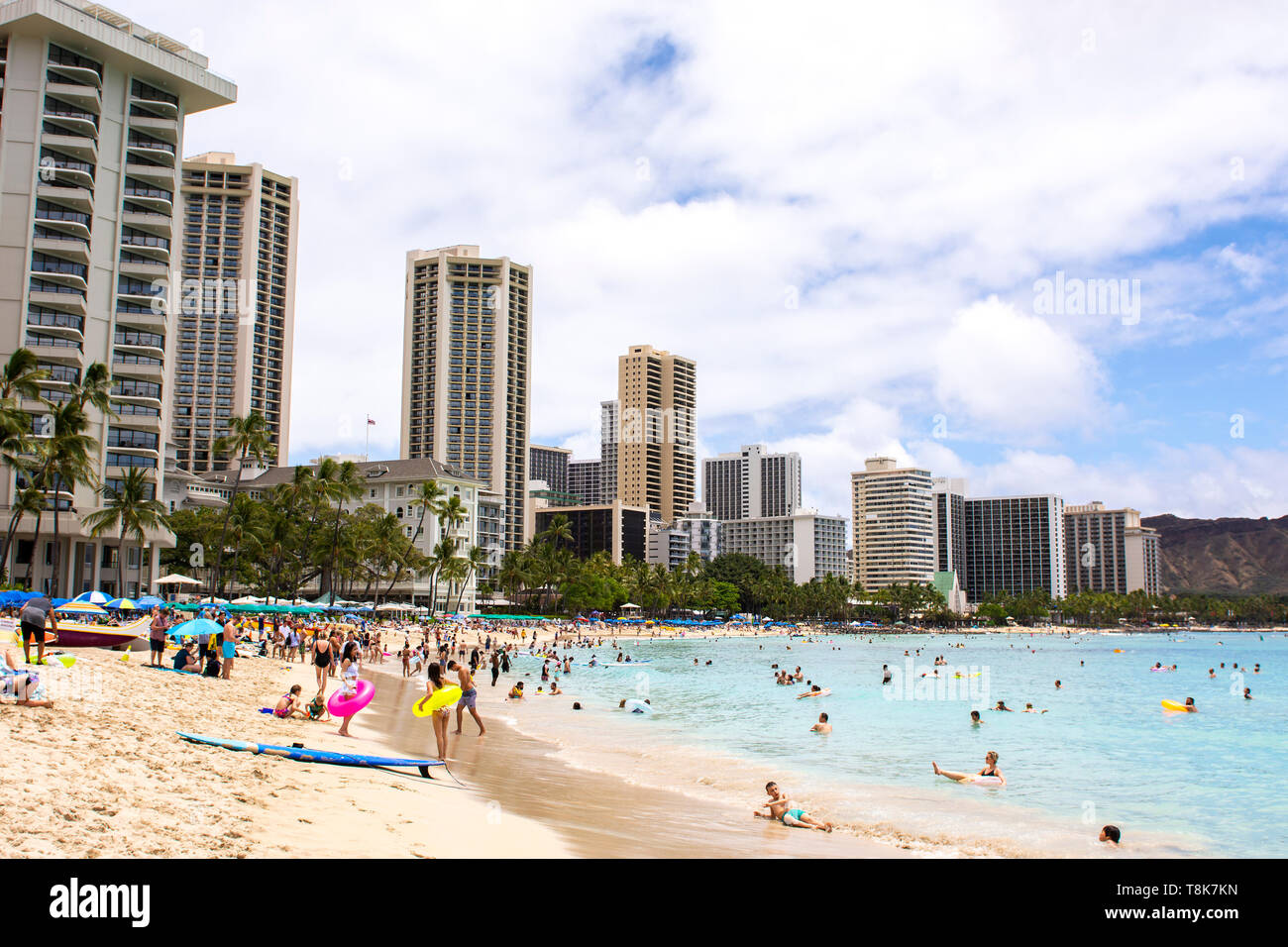 Beach goes enjoying the sun, sand and waves of Waikiki Beach, Honalulu ...