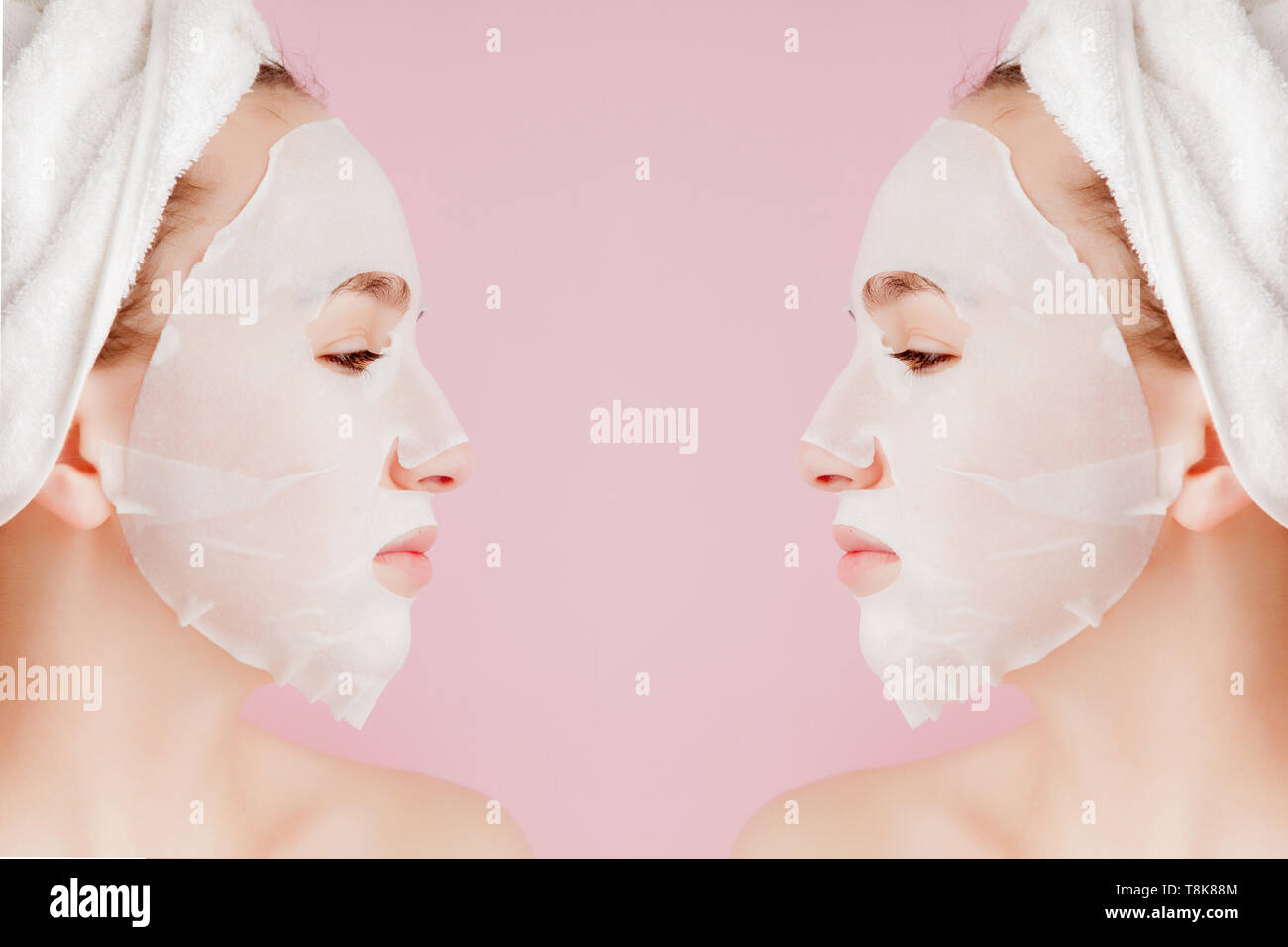 Beautiful young woman is applying a cosmetic tissue mask on a face on a ...