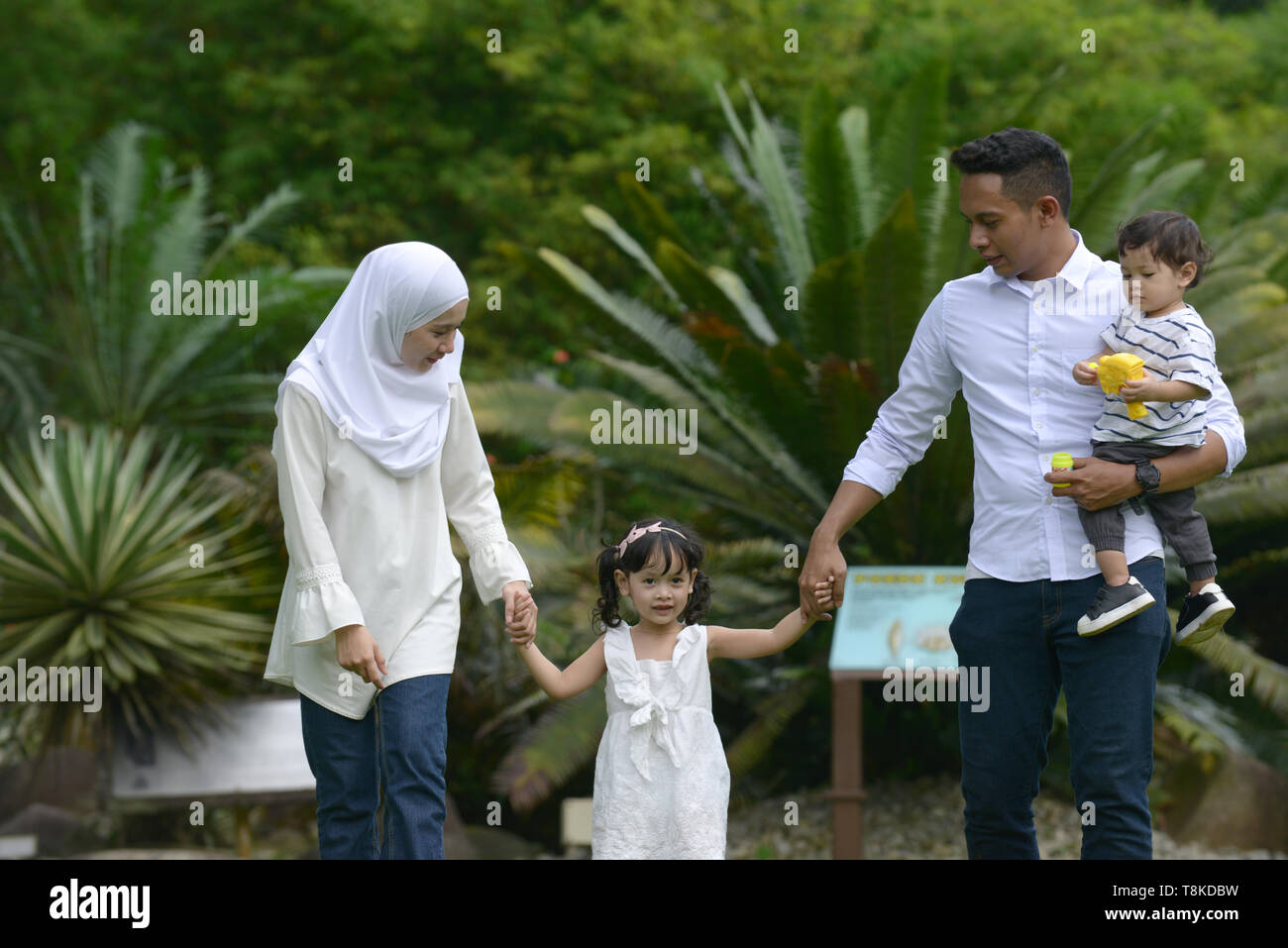 malay family enjoying quality time with father, son , mother and ...