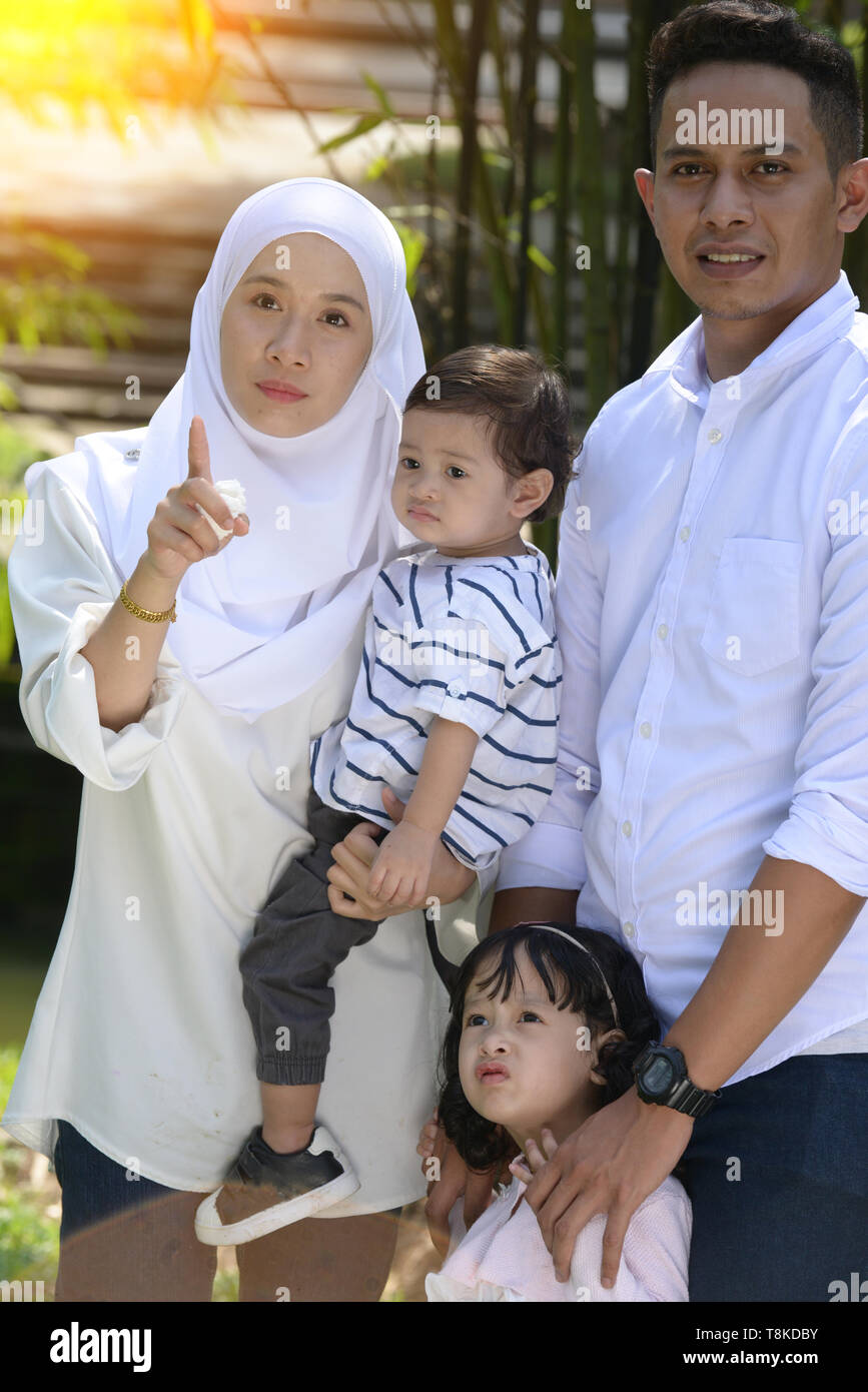 malay family enjoying quality time with father, son , mother and ...