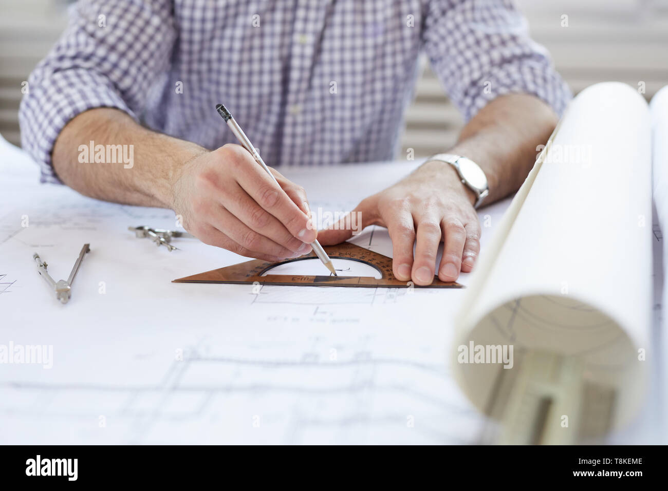 Engineer Drawing Plans at Workplace Stock Photo - Alamy