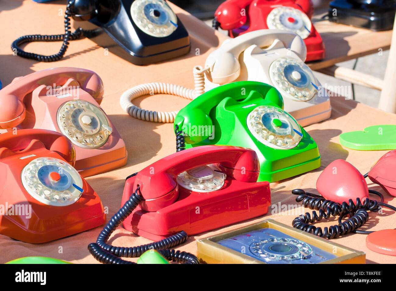 Old colored plastic analog phone in a flea market Stock Photo - Alamy