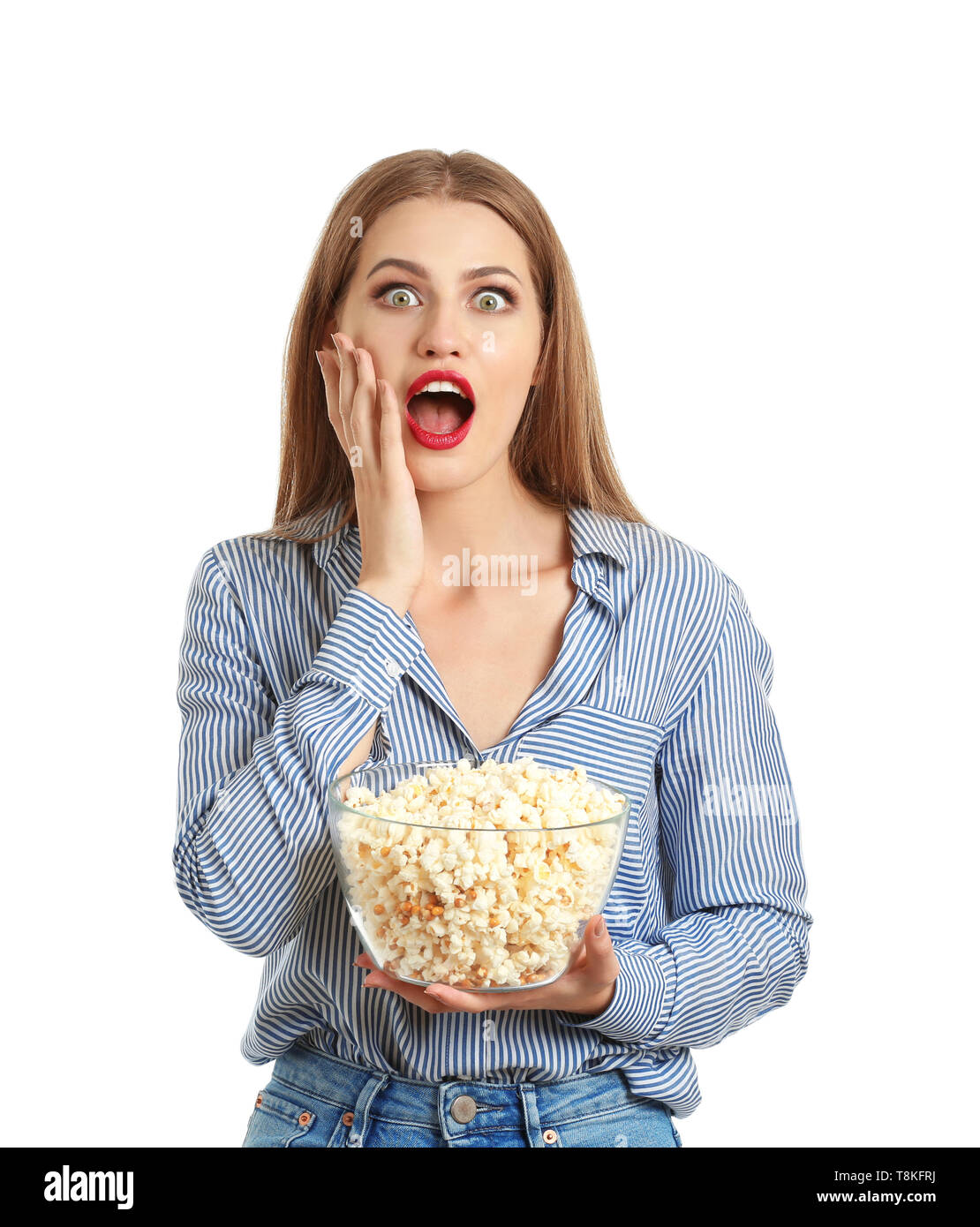 Emotional young woman with bowl of popcorn on white background Stock ...