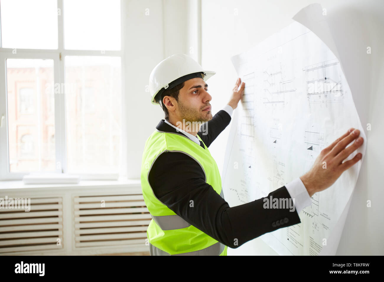Engineer Studying Plans on Site Stock Photo - Alamy