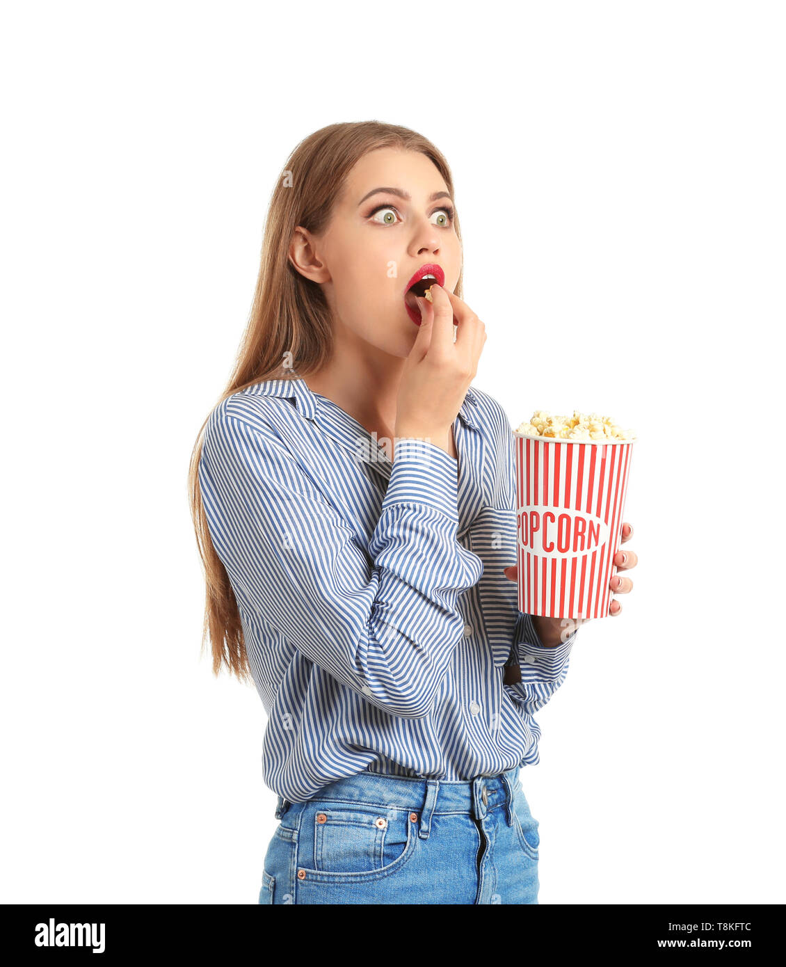 Emotional young woman eating popcorn on white background Stock Photo ...