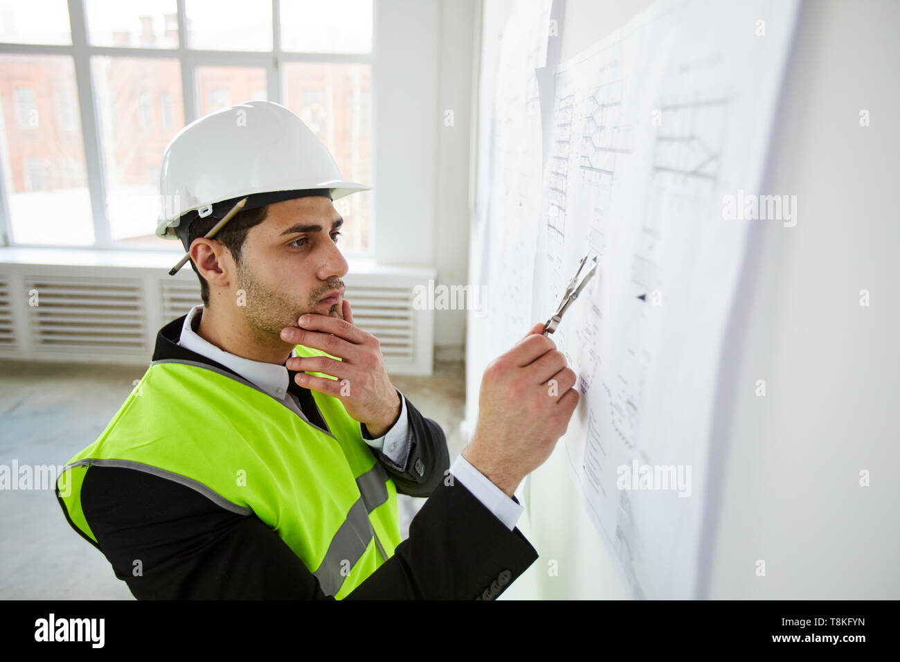 Engineer Thinking over Plans Stock Photo - Alamy