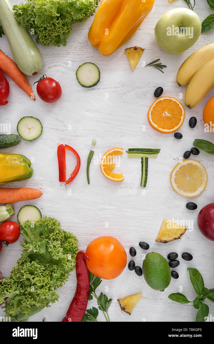 Composition with healthy products and word DIET on light wooden ...