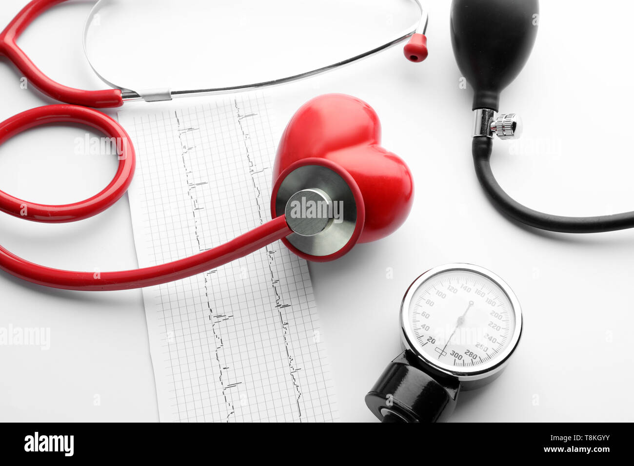 Medical stethoscope, sphygmomanometer, cardiogram and red heart on ...