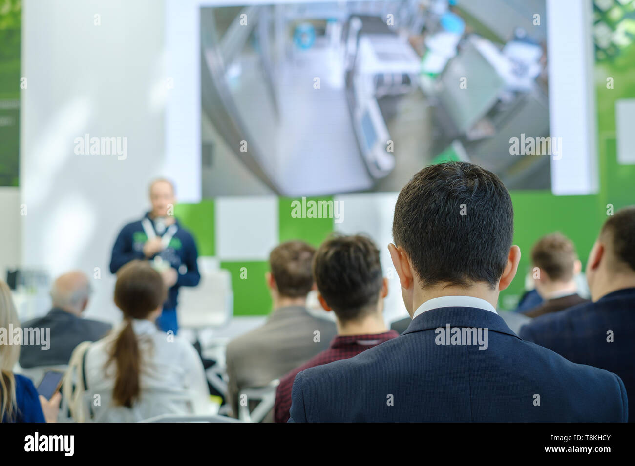 Audience listens to the lecturer at the business conference, back view ...