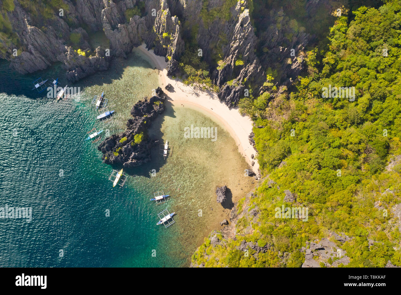 Beautiful lagoon surrounded by cliffs.Aerial drone view of swimmers ...