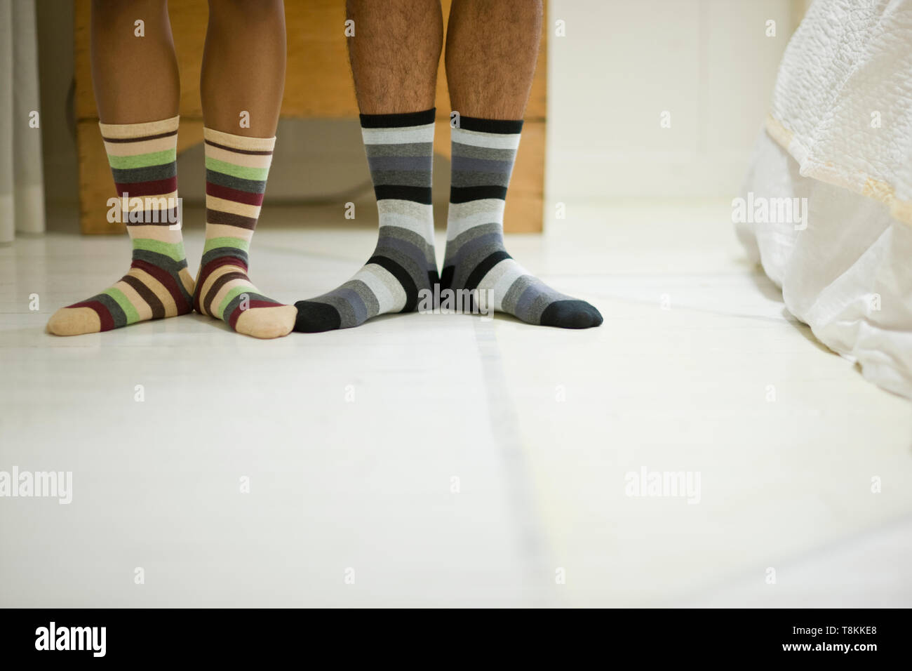 Couple in matching striped socks standing next to each other Stock ...