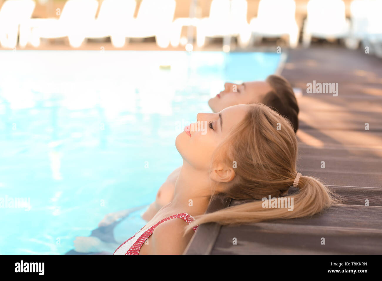 Happy young couple resting in swimming pool at resort Stock Photo - Alamy