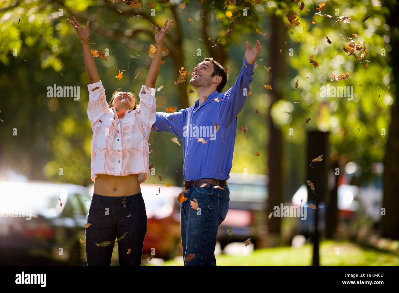 Two girls throwing leaves hi-res stock photography and images - Alamy
