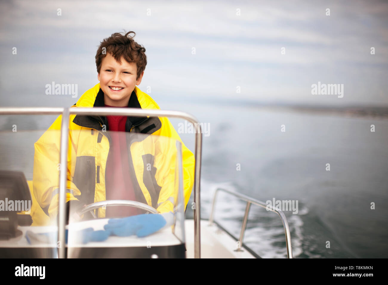 Boy driving boat Stock Photo - Alamy Boy driving boat Stock Photo - Alamy