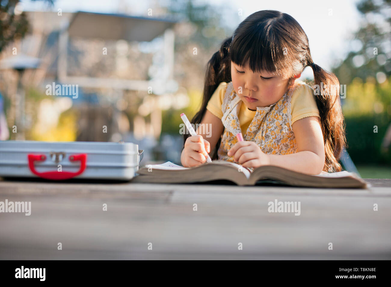 Young girl coloring in a coloring book Stock Photo - Alamy