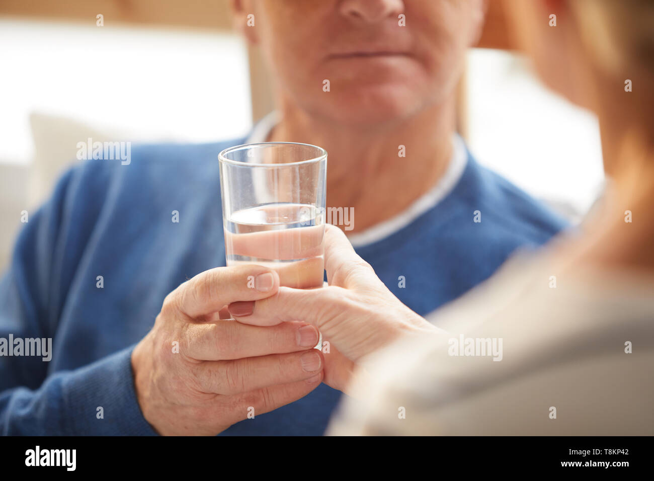 Woman giving glass water elderly hi-res stock photography and images ...