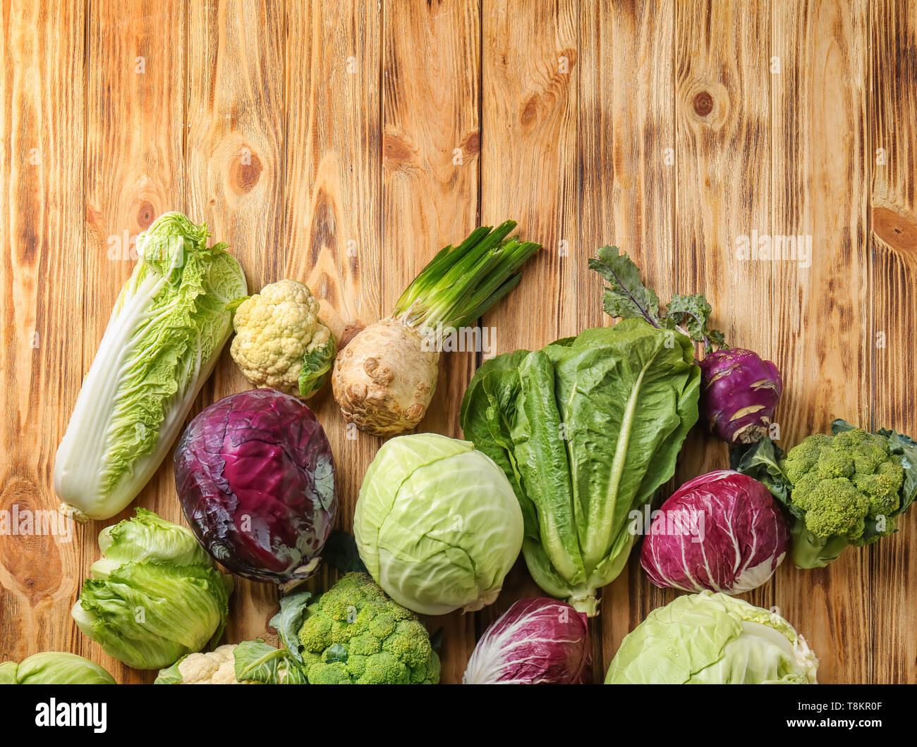Different types of cabbage on wooden background Stock Photo - Alamy