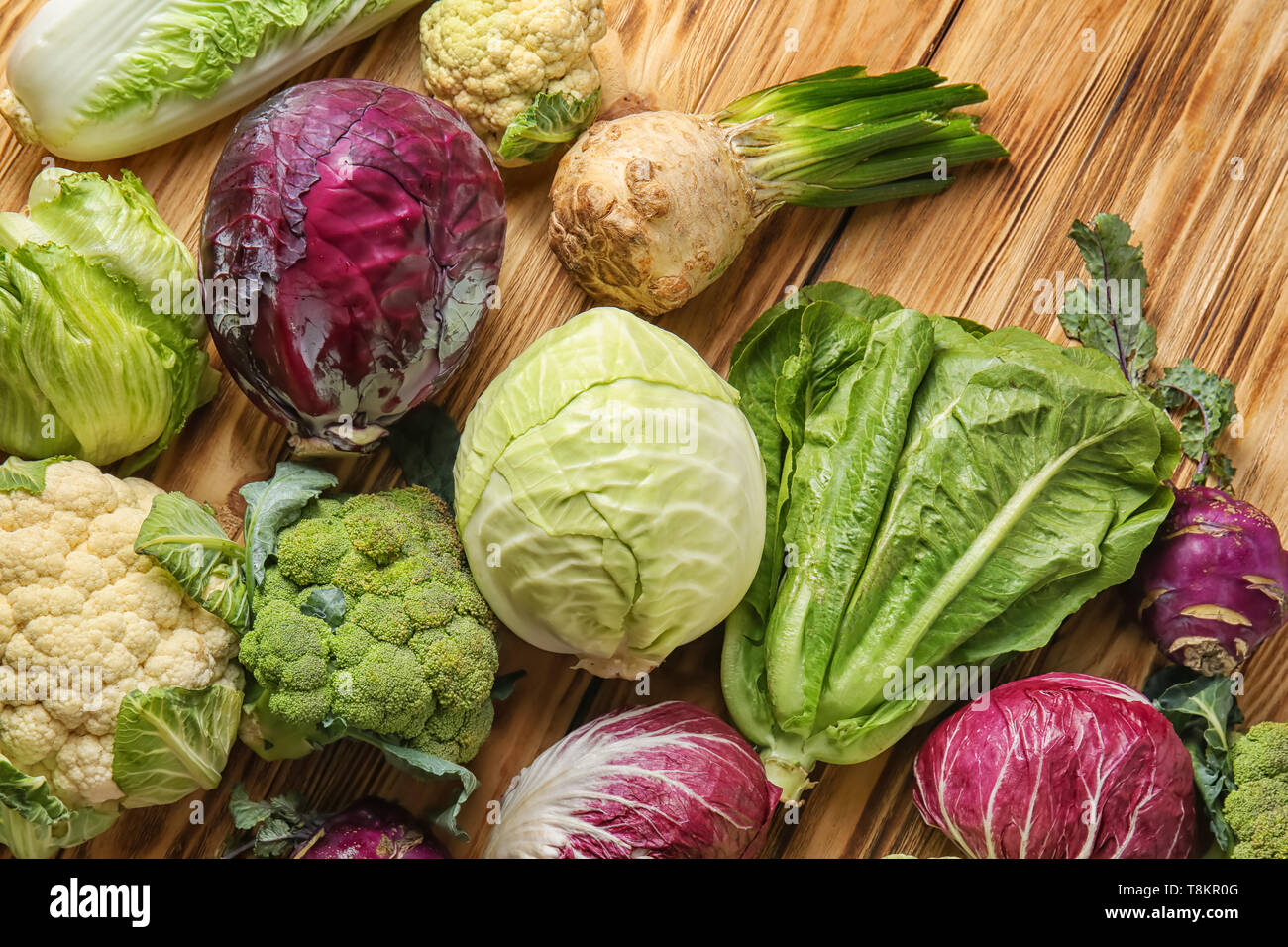 Different types of cabbage on wooden background Stock Photo - Alamy
