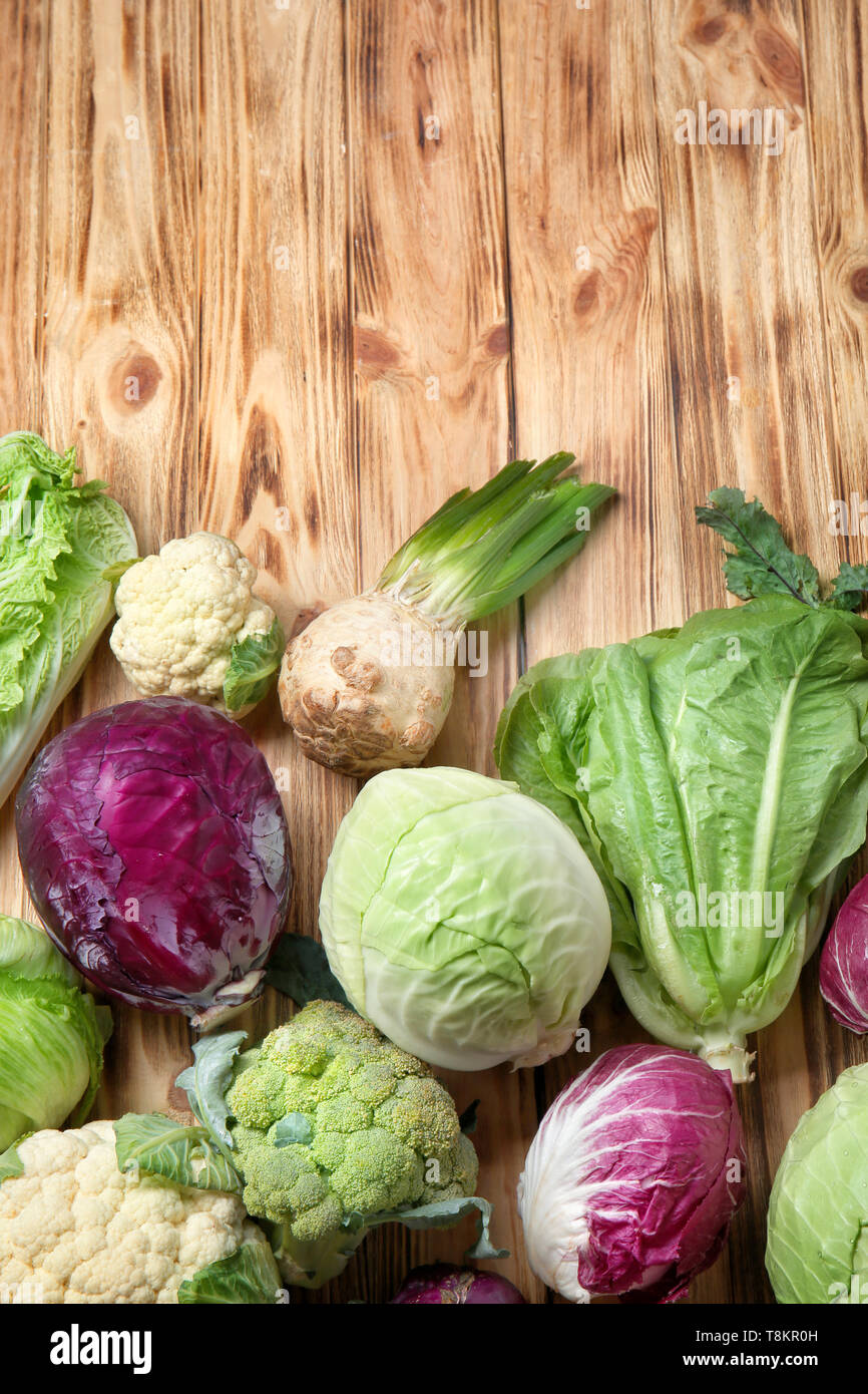 Different types of cabbage on wooden background Stock Photo - Alamy