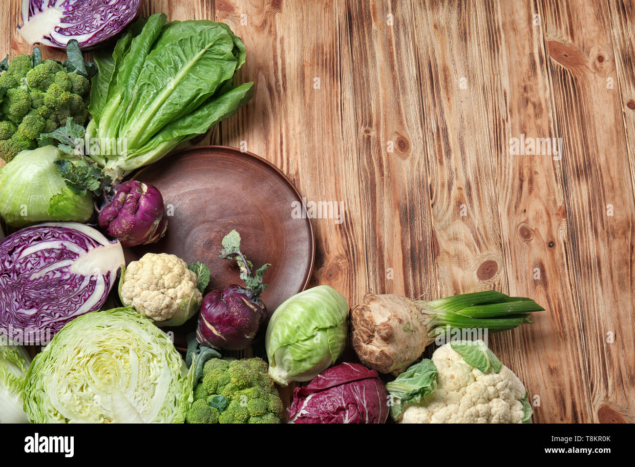 Different types of cabbage on wooden background Stock Photo - Alamy