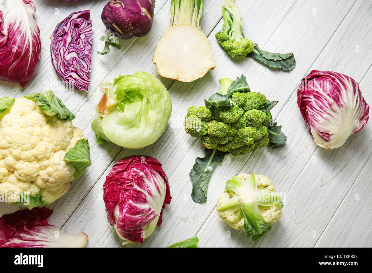 Different types of cabbage on light wooden background Stock Photo - Alamy