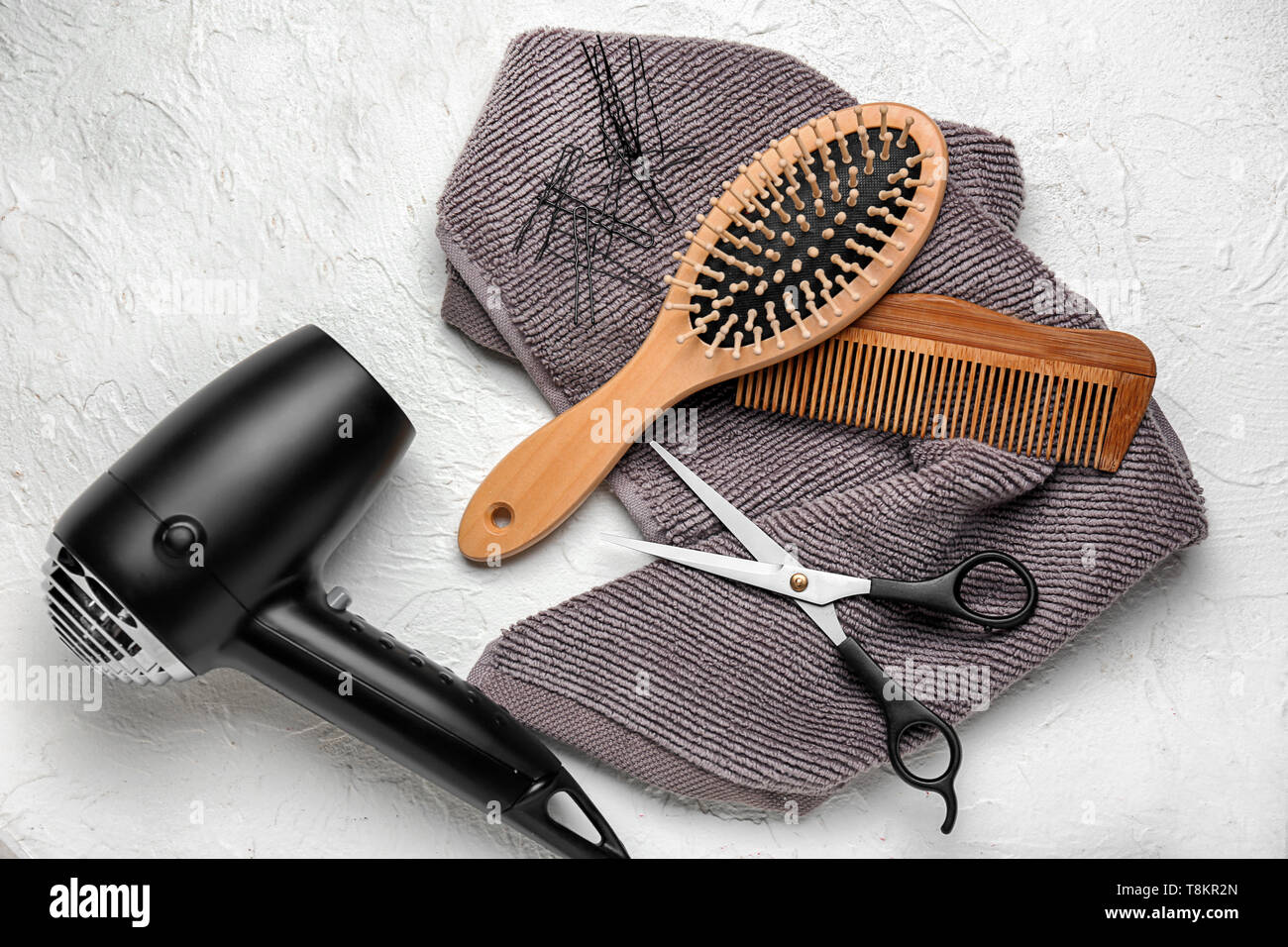 Professional hairdresser's tools with hair dryer on light background ...
