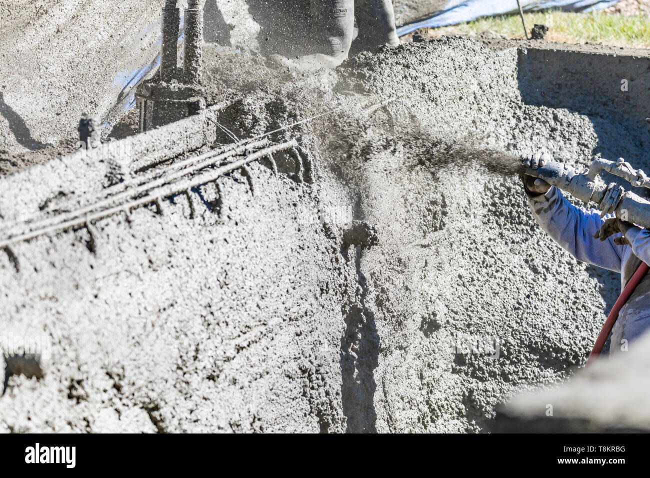 Pool Construction Worker Shooting Concrete, Shotcrete or Gunite Through ...