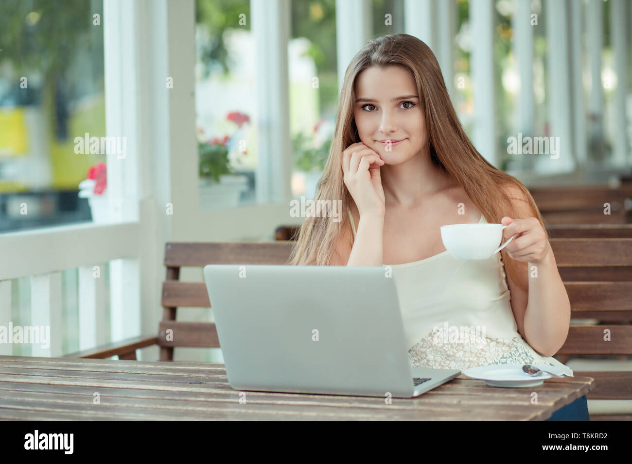 Happy casual beautiful woman posing looking at you camera, sited in ...