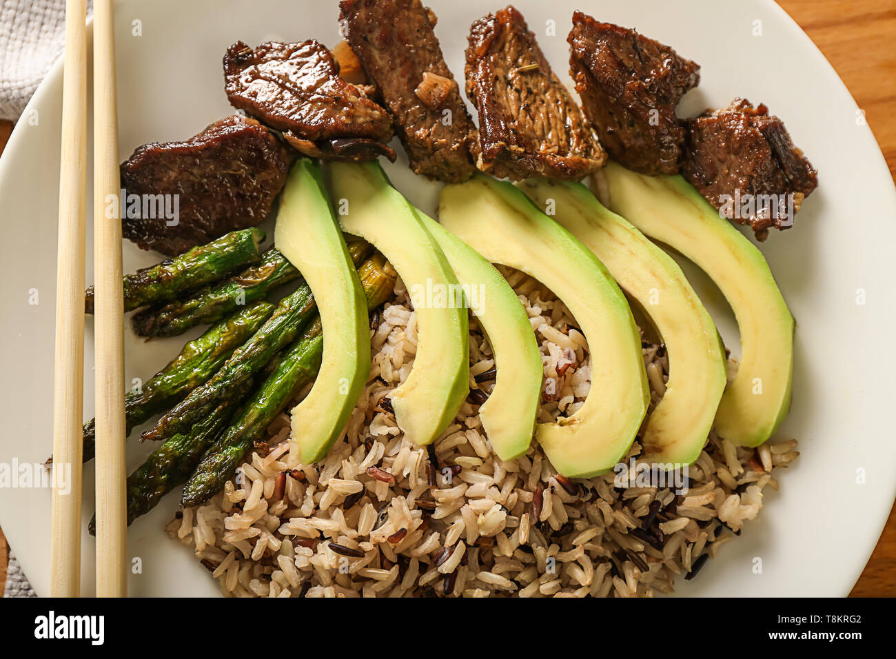 Plate with boiled rice, vegetables and meat on table, closeup Stock ...