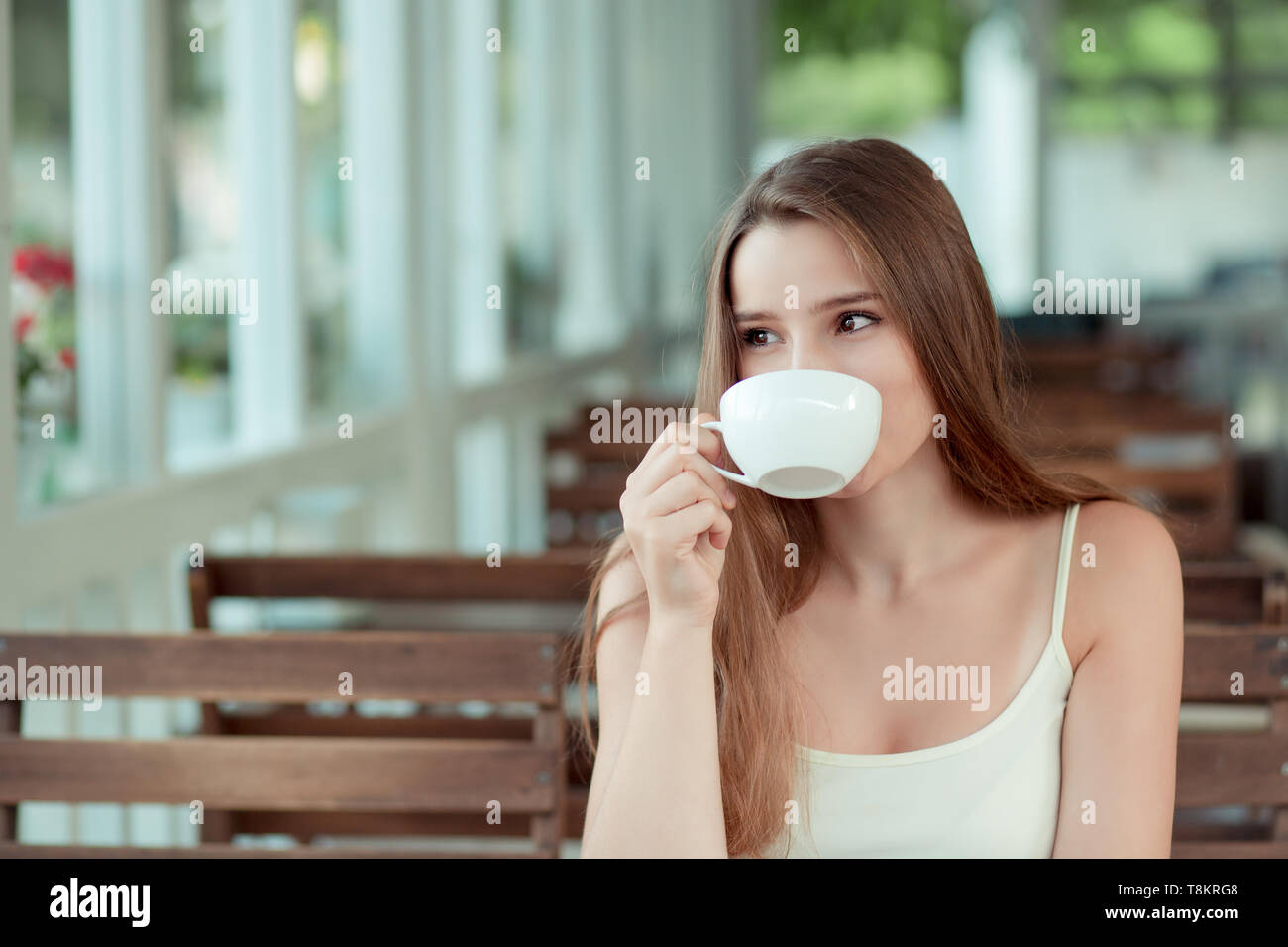 Coffee. Young beautiful Girl woman drinking Tea Cappuccino in trendy ...