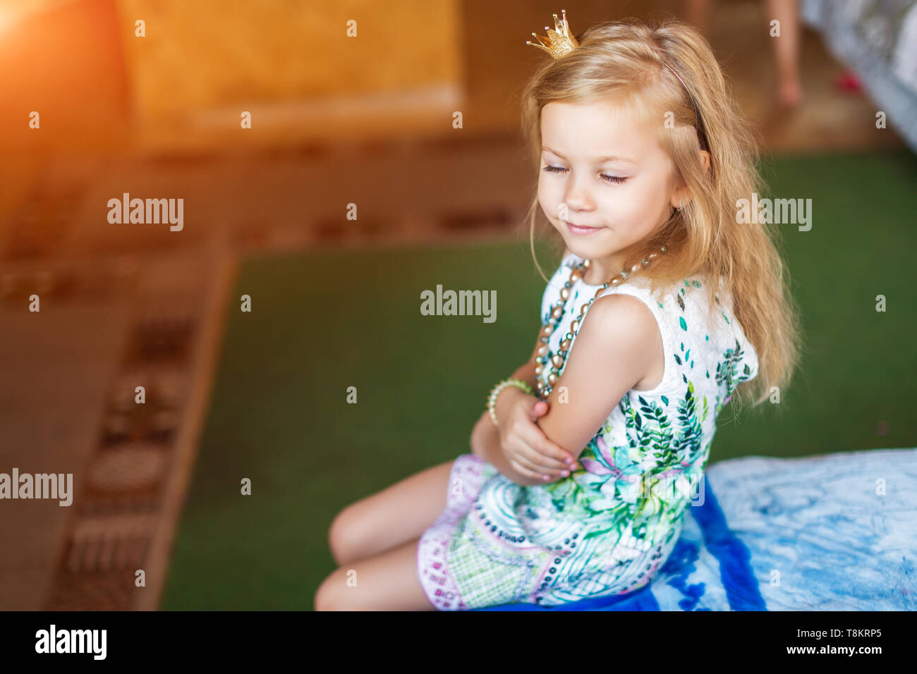 Cute kid princess posing with closed eyes Stock Photo - Alamy