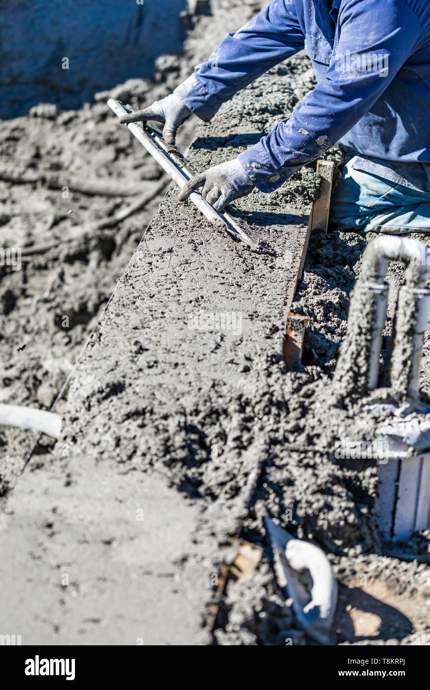 Pool Construction Worker Working With A Smoother Rod On Wet Concrete ...