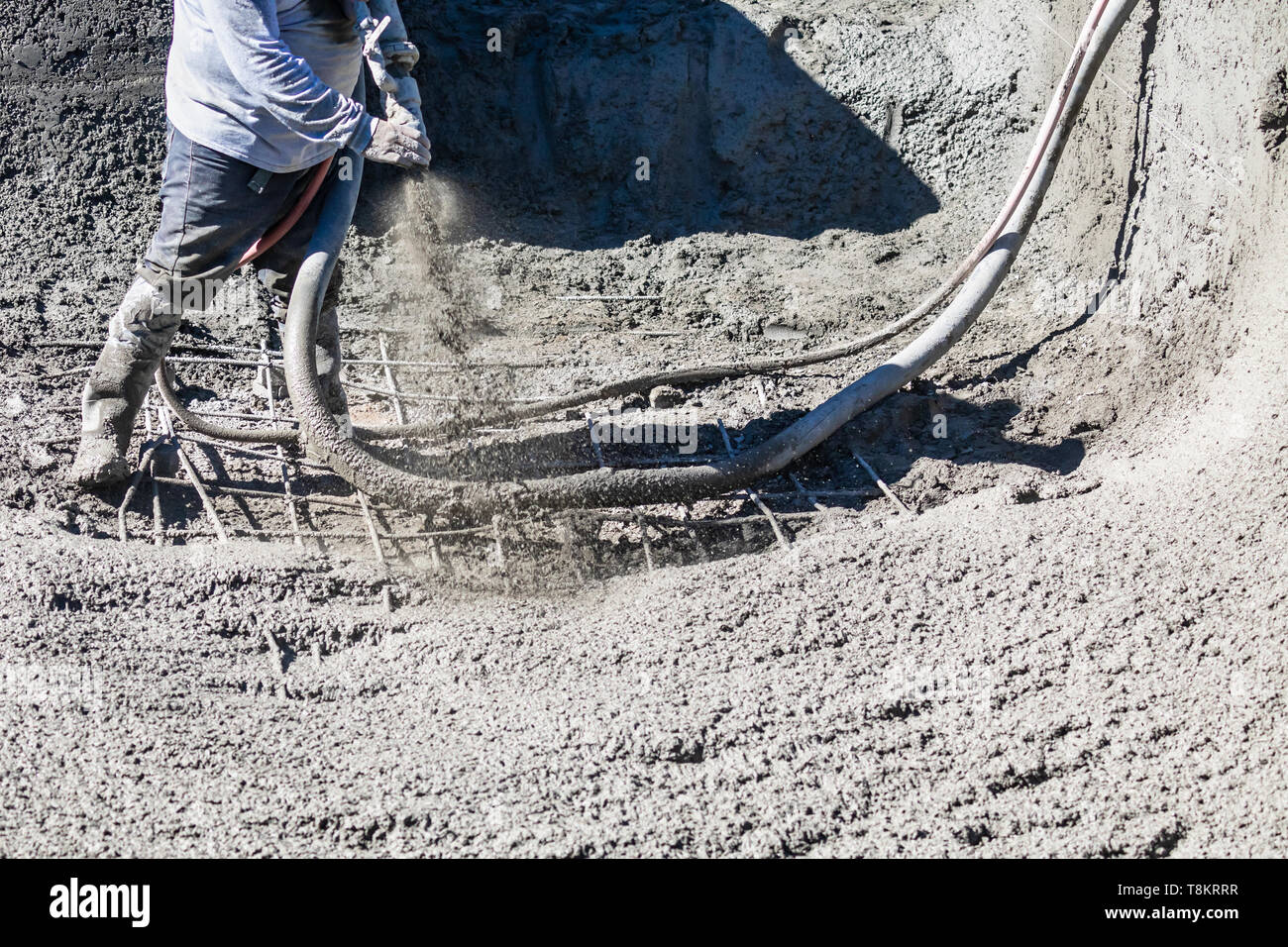 Pool Construction Worker Shooting Concrete, Shotcrete or Gunite Through ...