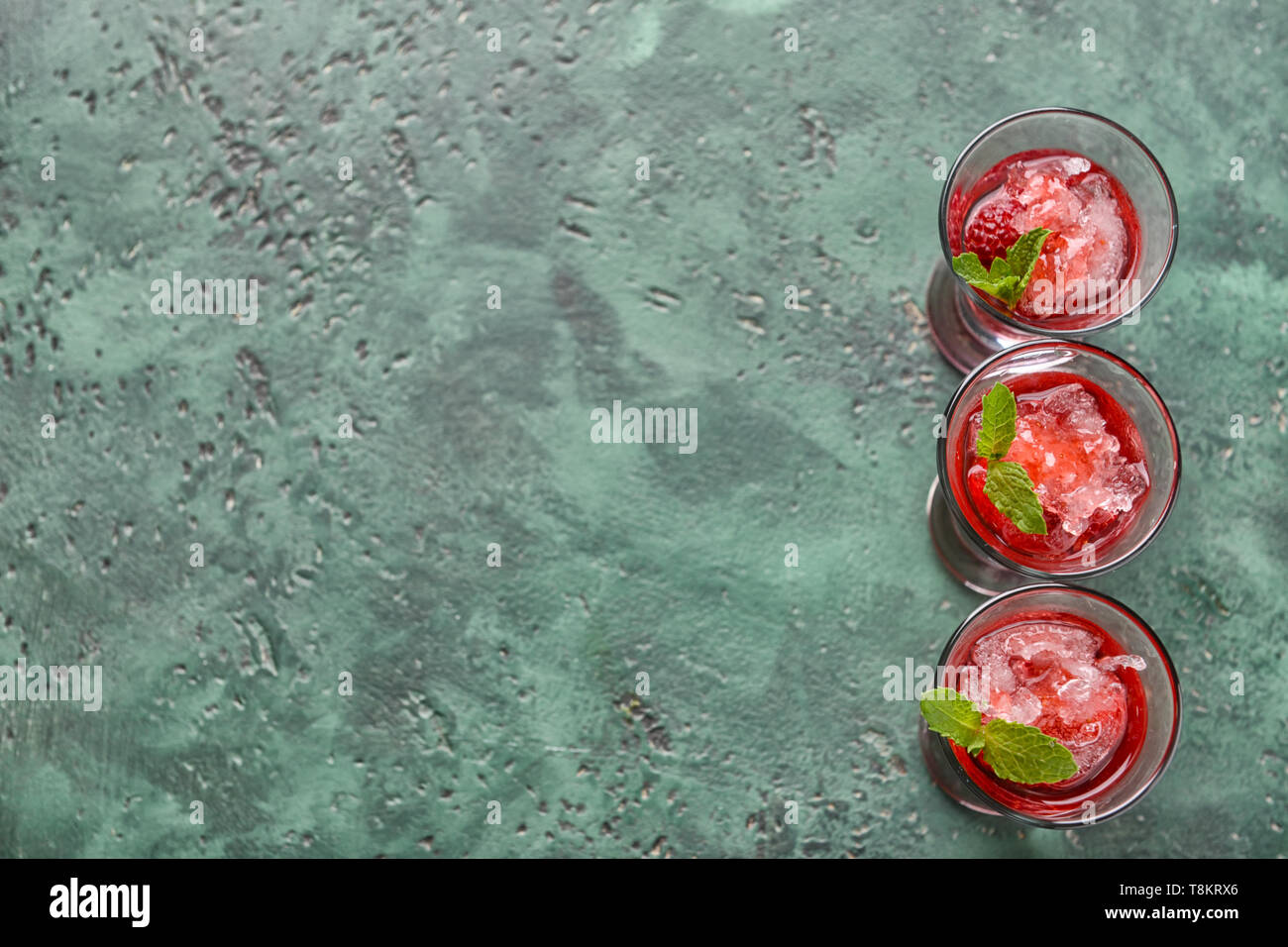 Fresh summer cocktail in shot glasses on color table Stock Photo - Alamy