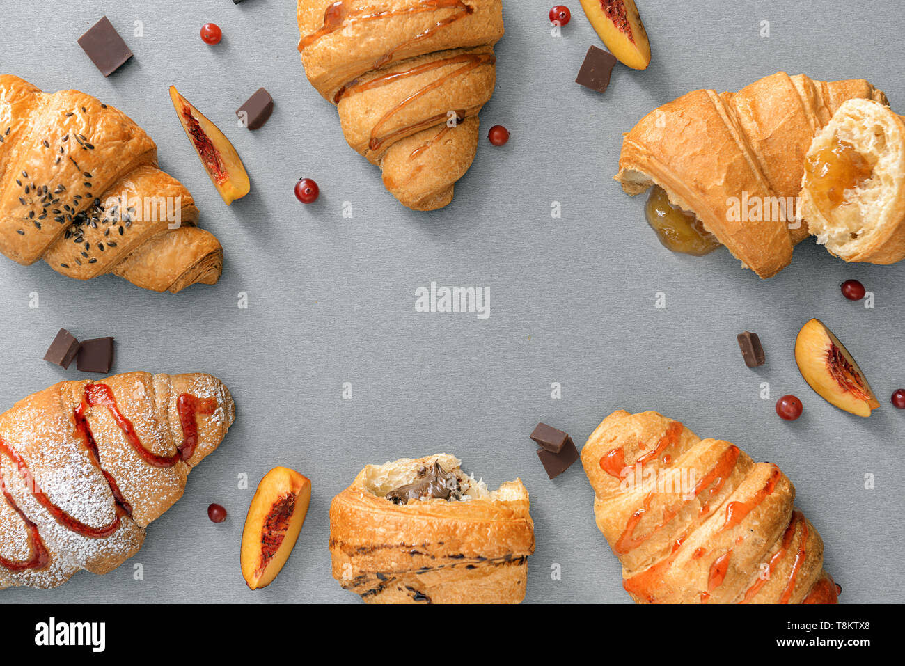 Different tasty croissants on grey table Stock Photo - Alamy