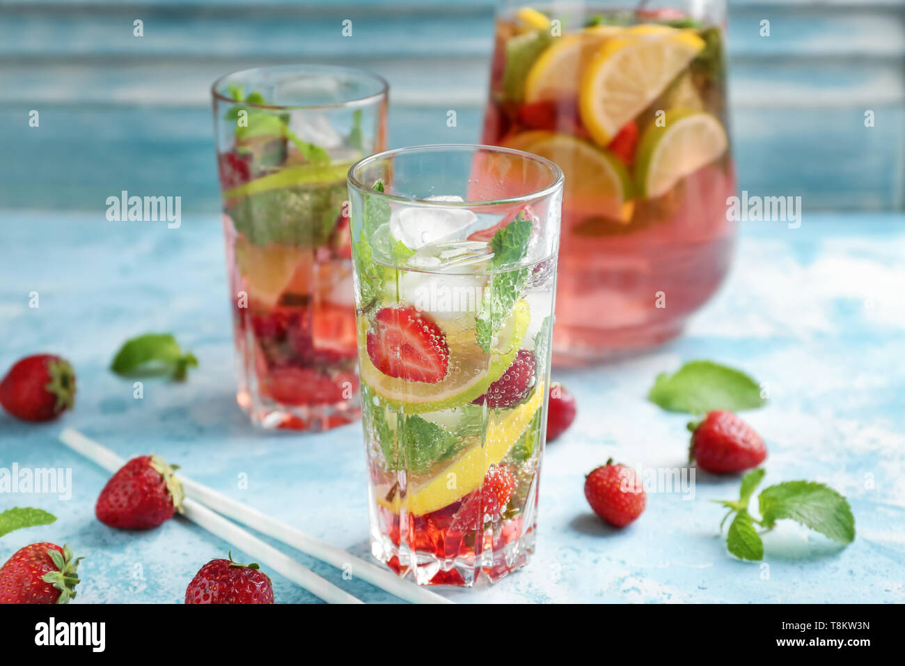 Glass of fresh strawberry lemonade on color table Stock Photo - Alamy